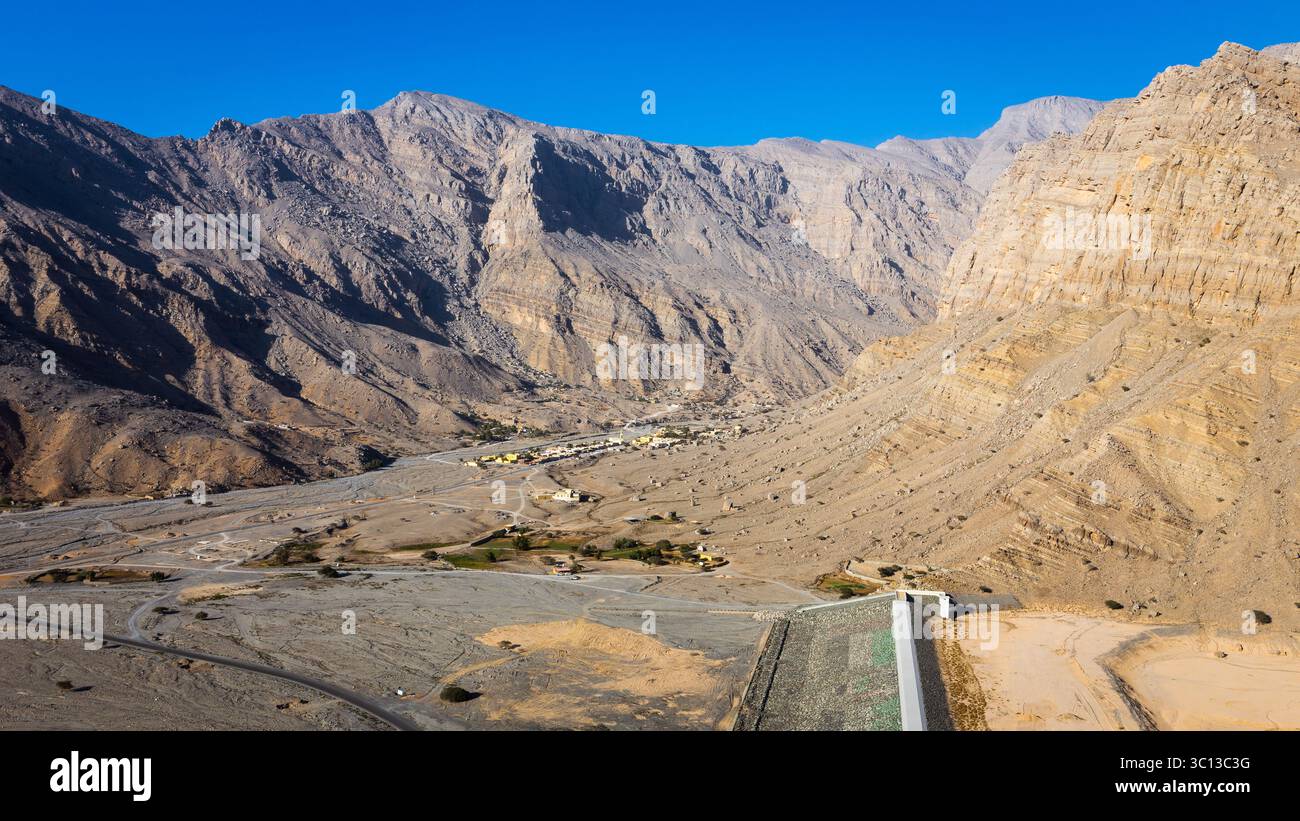 Wadi Ghalilah valley with dry riverbed and small farm mountain village ...
