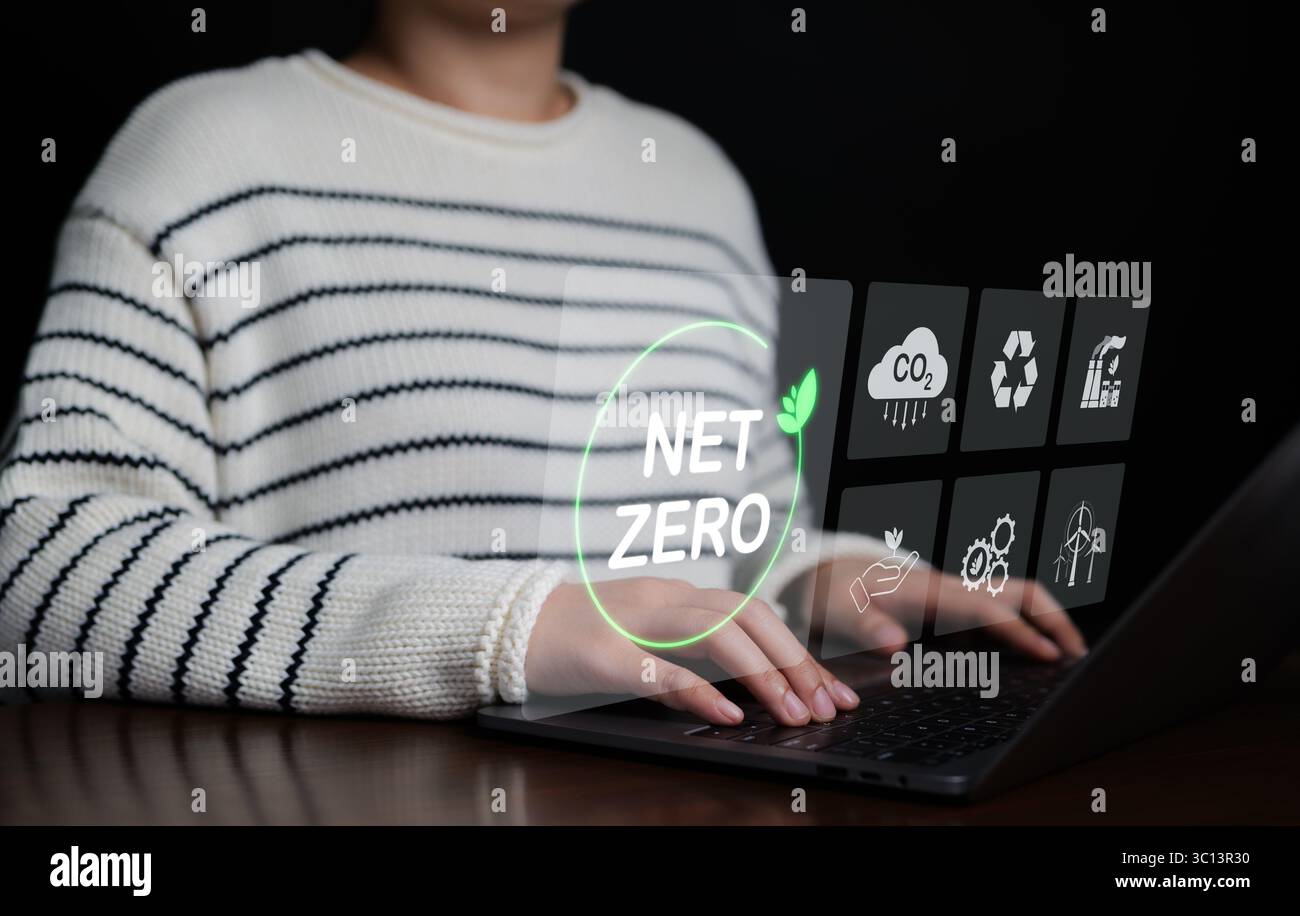 Woman using laptop computer working with Net Zero icons. Climate ...