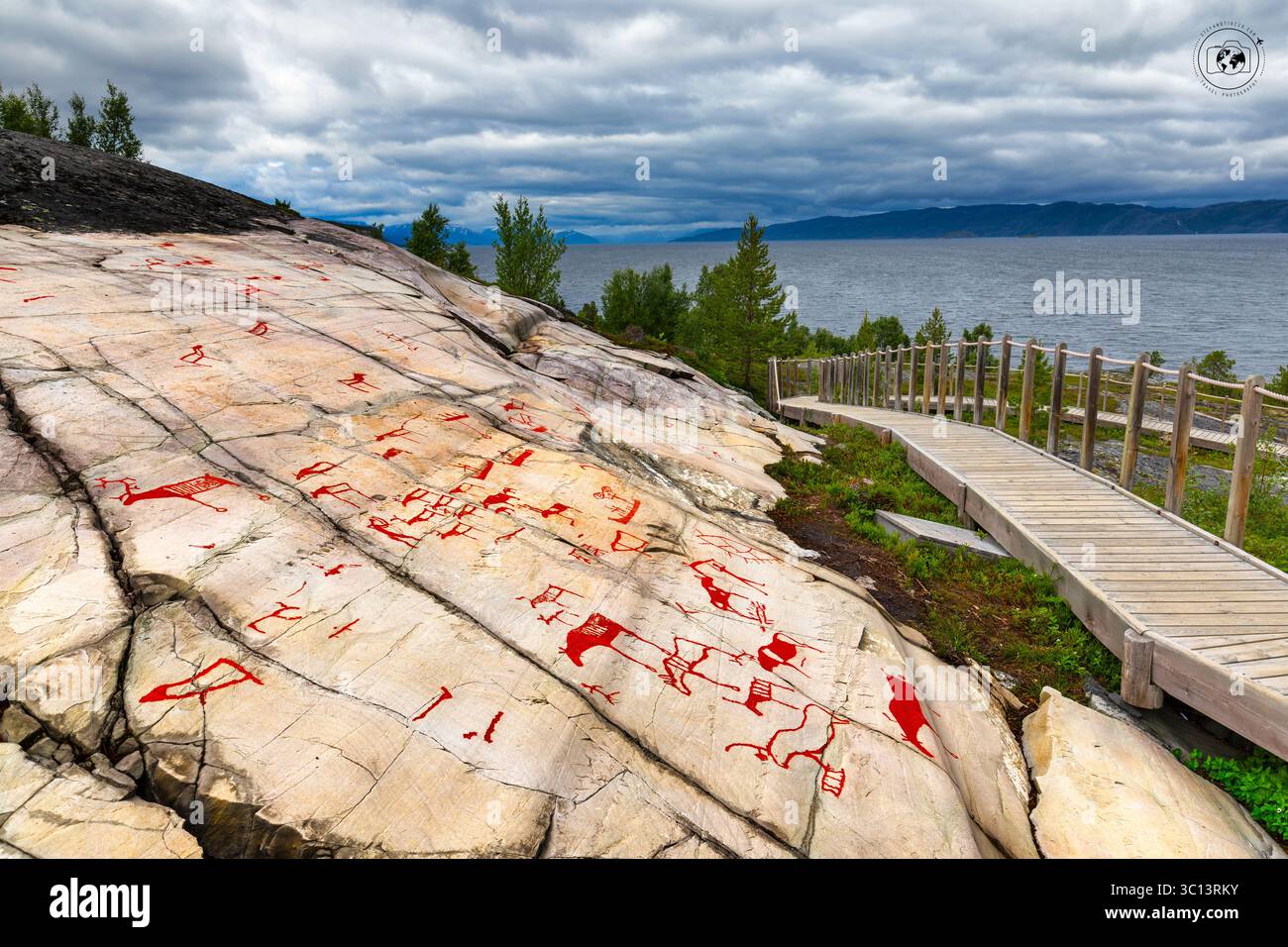 View of ancient red rock carvings etched into a sloping stone surface ...