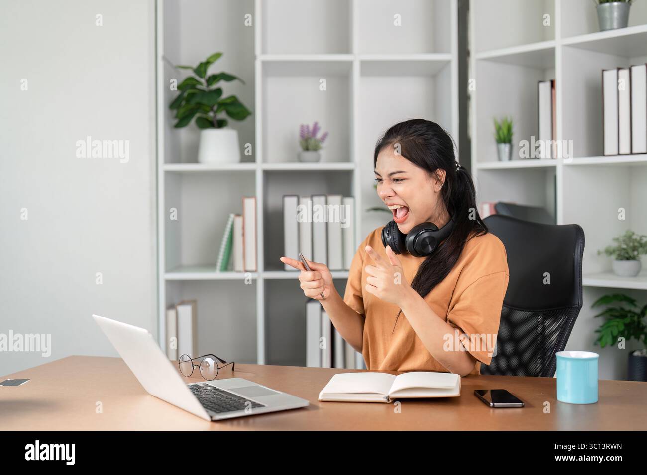 Young Female Employee Celebrates Success in Modern Office Environment ...
