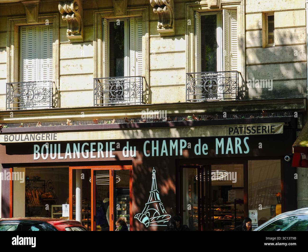 People outside the Boulangerie du Champ de Mars, a neighborhood bakery ...