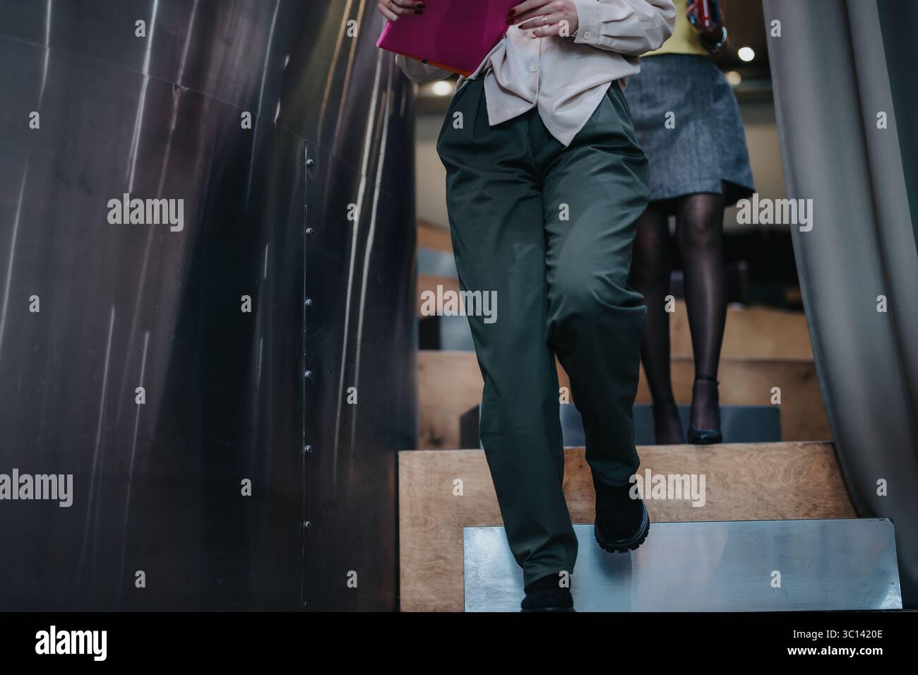Dynamic perspective of professionals walking down modern stairs Stock ...