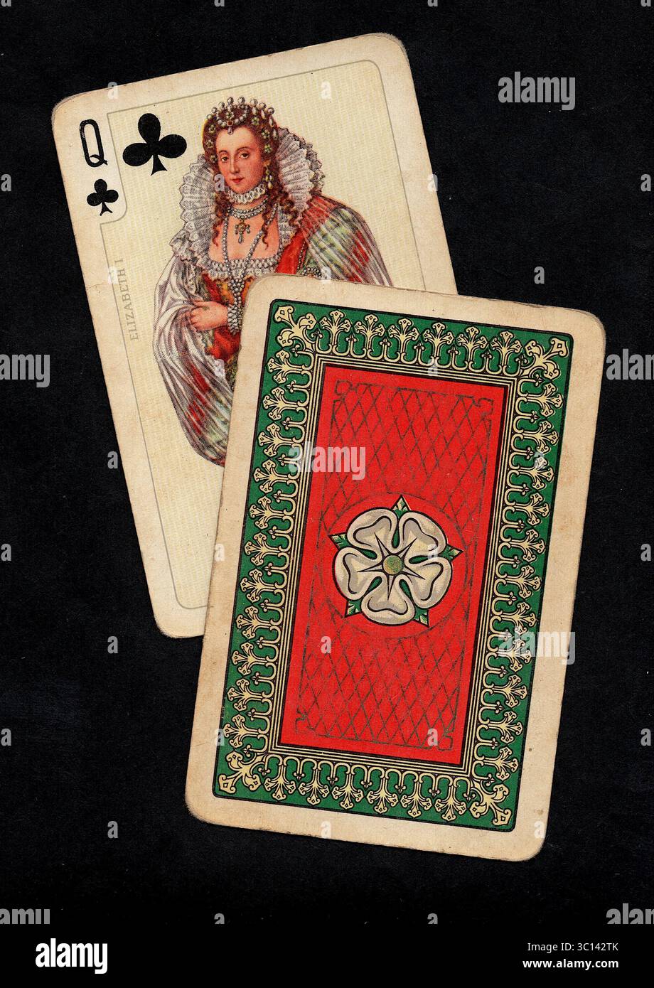 A pair of antique playing cards with one card revealed showing a ...