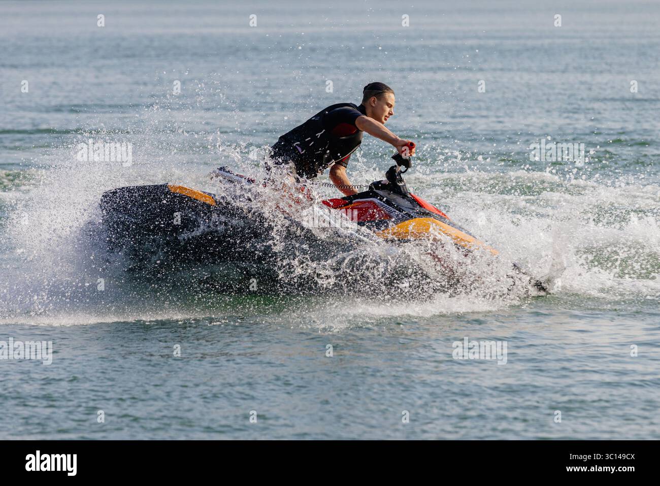 Young guy rides jet ski hi-res stock photography and images - Alamy
