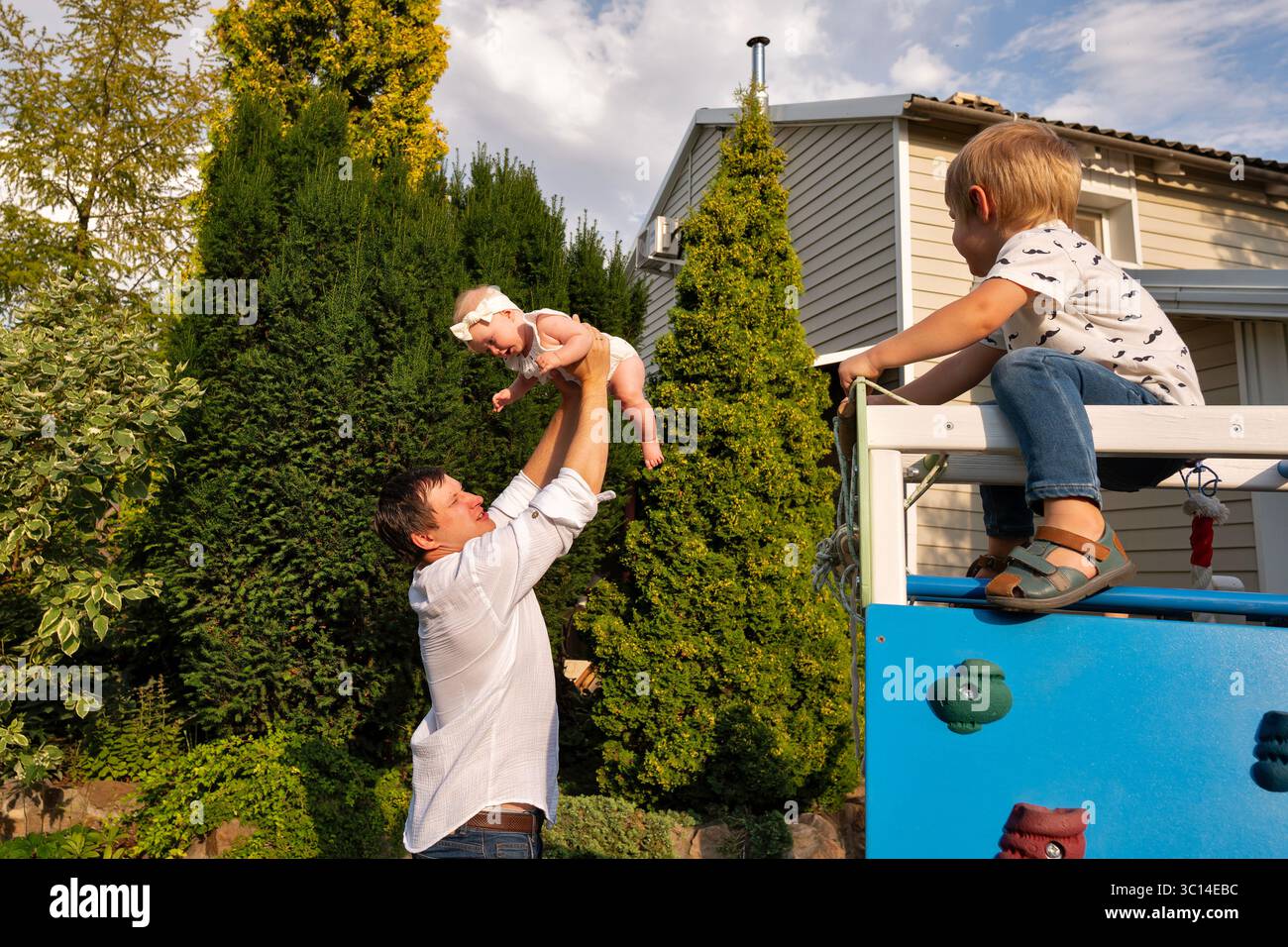 Father lifts laughing baby hi-res stock photography and images - Alamy