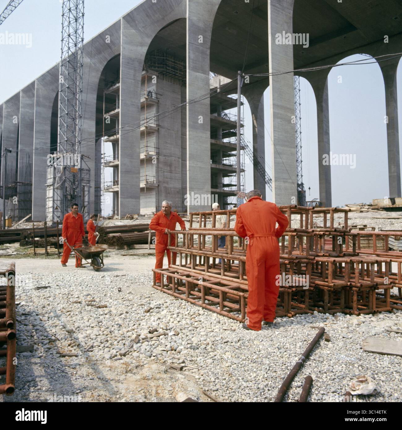 Two workers moving steel rebar cages for the concrete cast on the ...