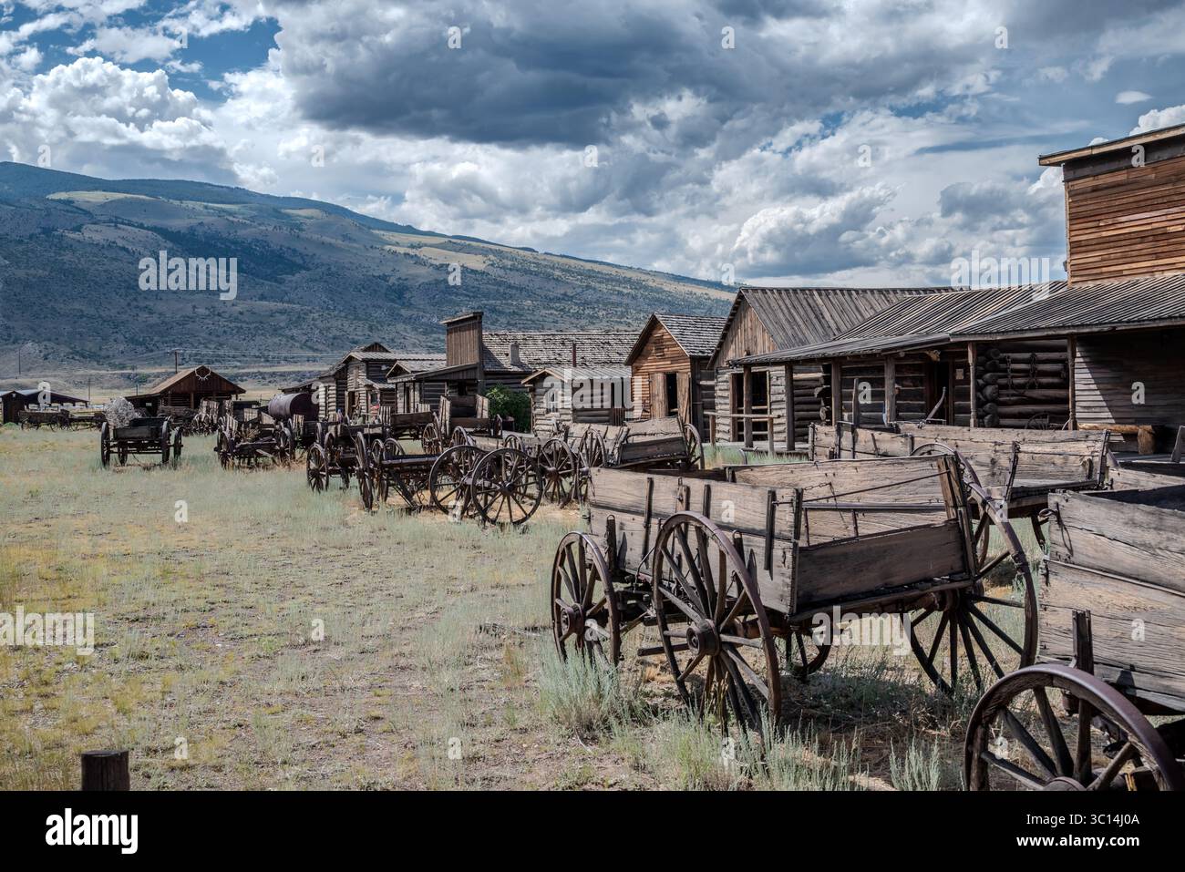 Historic log cabins and antique wagons in Cody, Montana, evoking the ...
