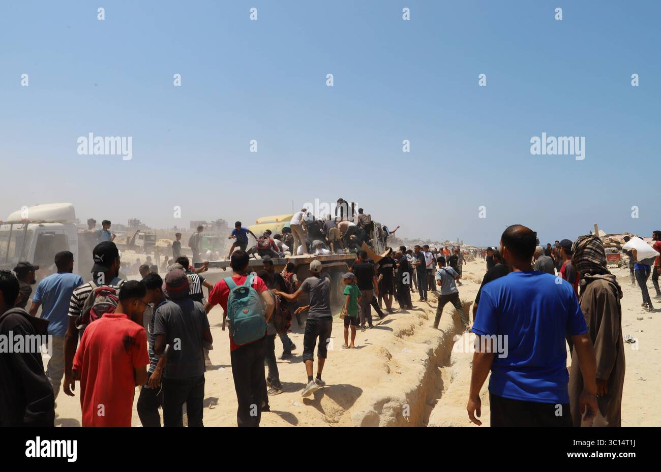 People make their way along al-Rashid street in western Jabalia People ...