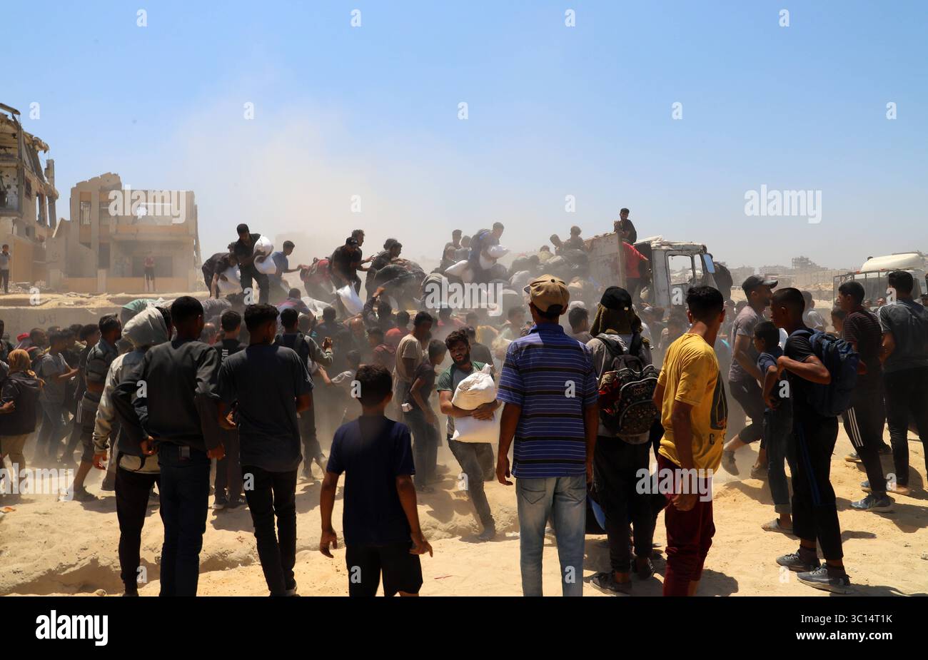 People make their way along al-Rashid street in western Jabalia People ...