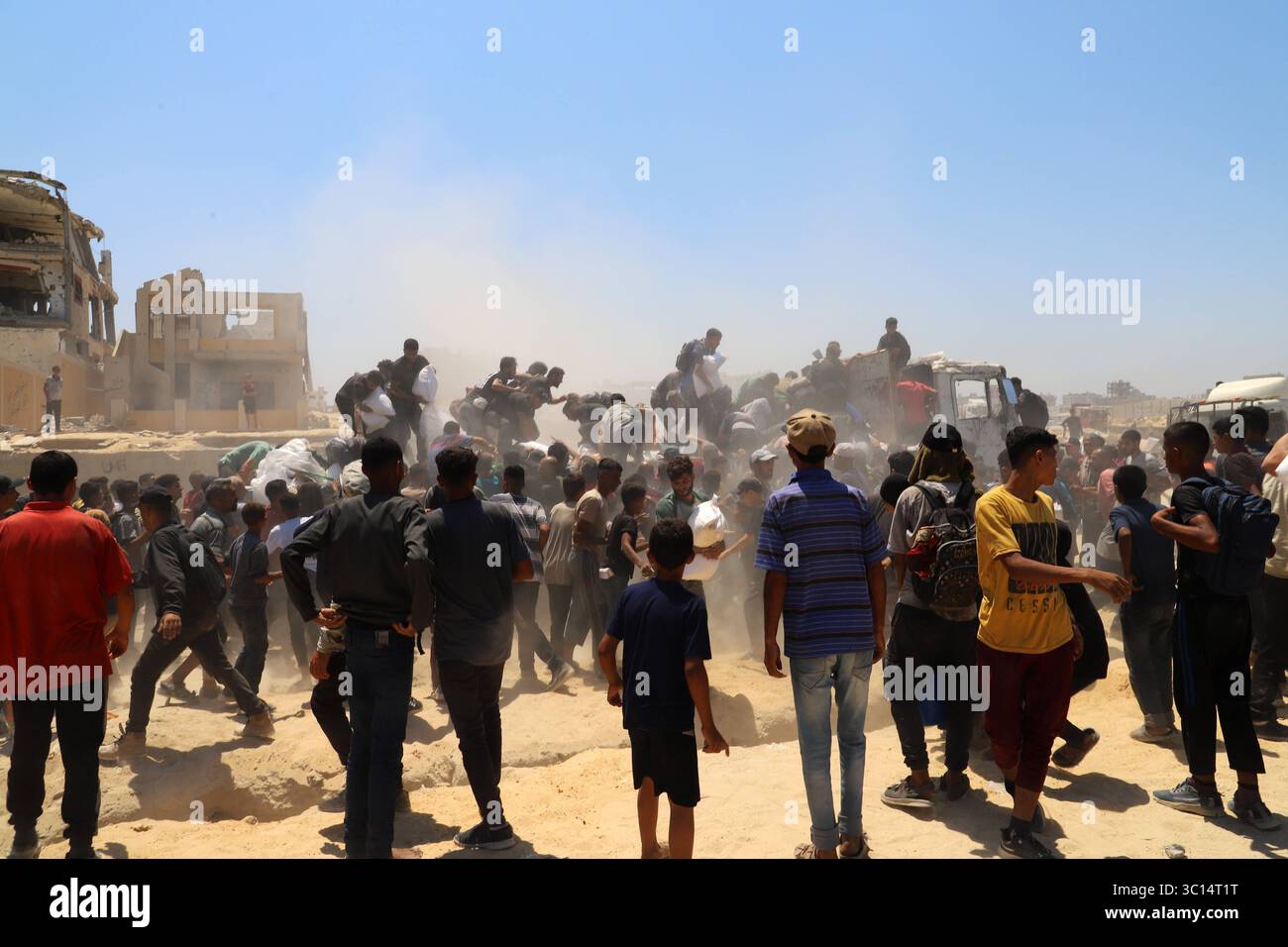People make their way along al-Rashid street in western Jabalia People ...