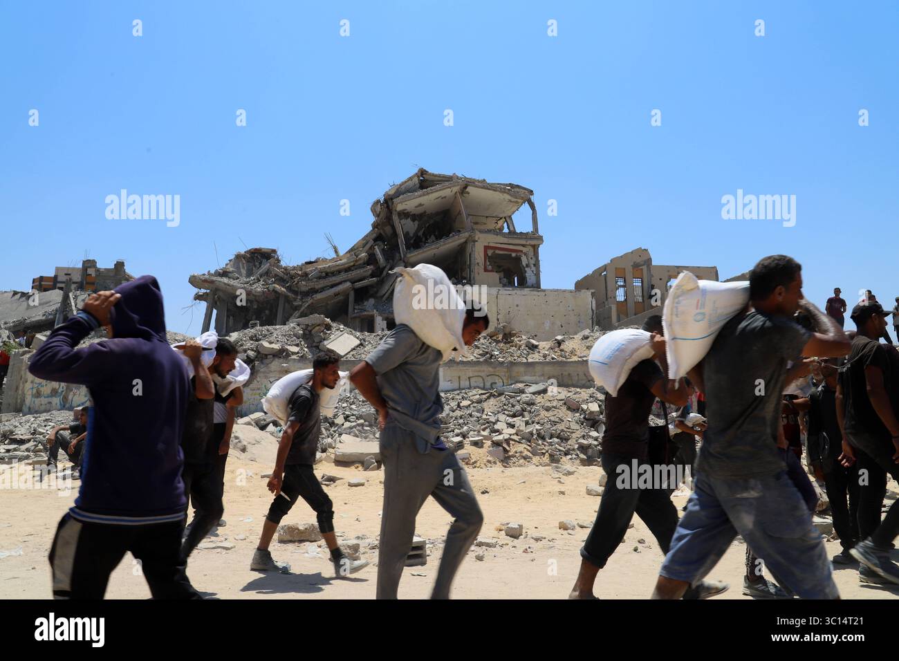 People make their way along al-Rashid street in western Jabalia People ...
