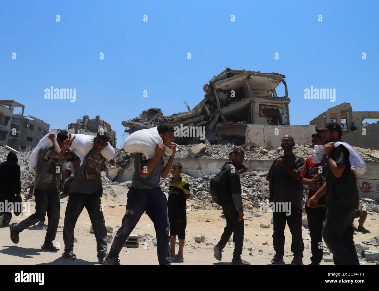 People make their way along al-Rashid street in western Jabalia People ...