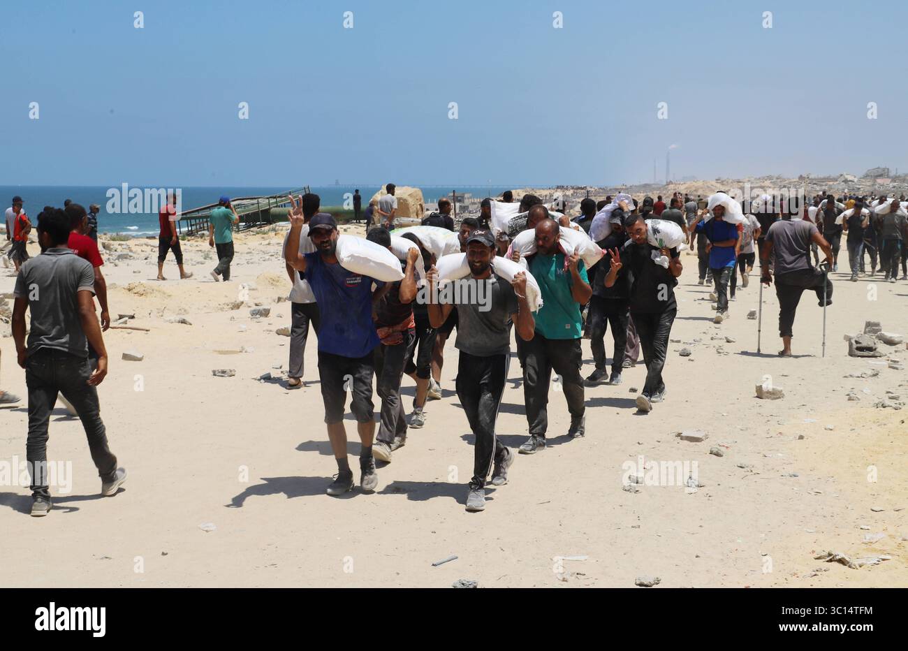 People make their way along al-Rashid street in western Jabalia People ...