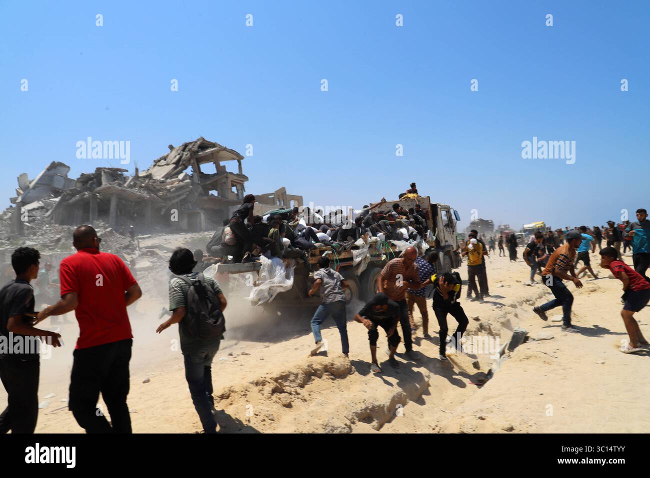 People make their way along al-Rashid street in western Jabalia People ...