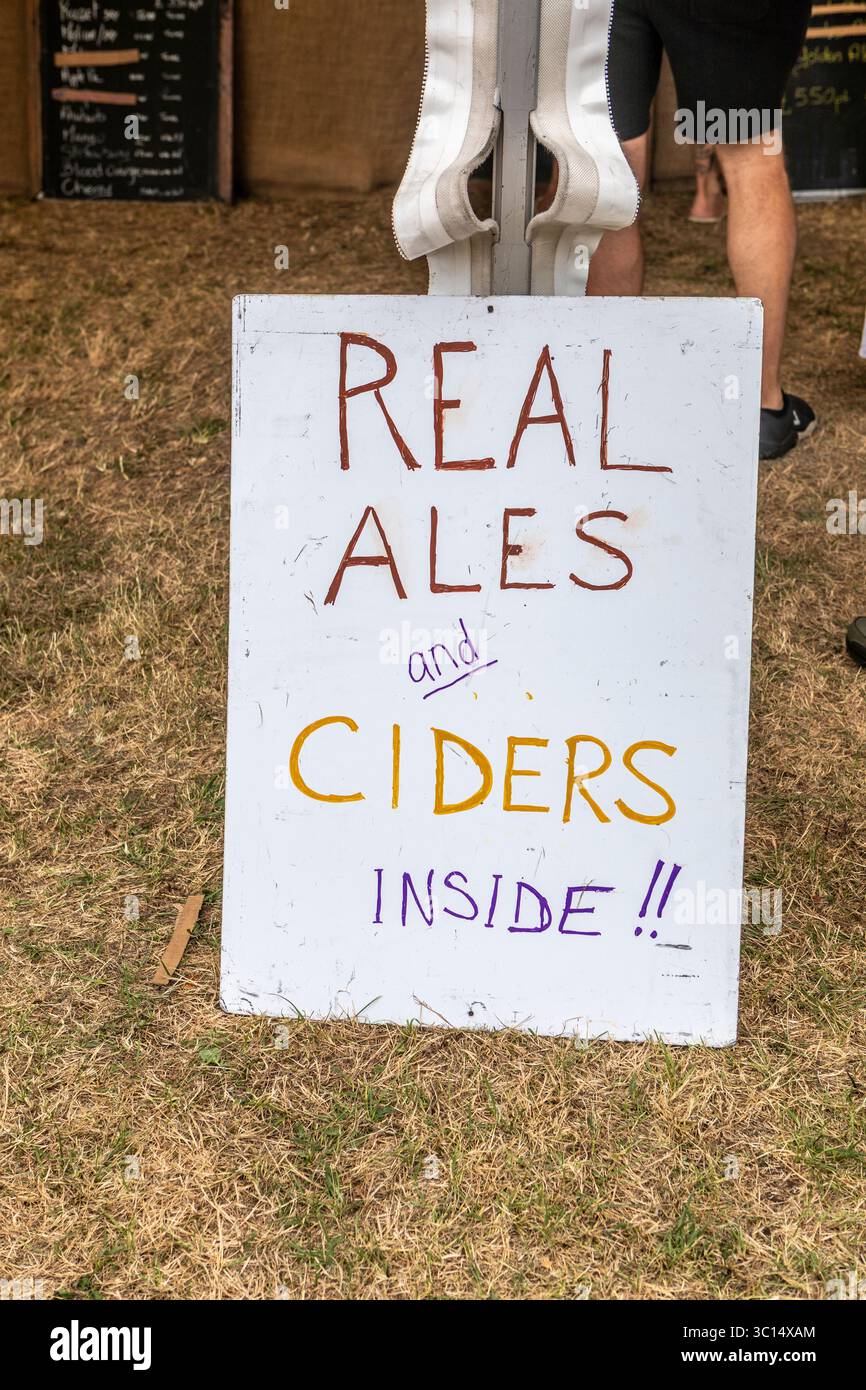 A basic handwritten sign for real ales and ciders at a local outdoor ...