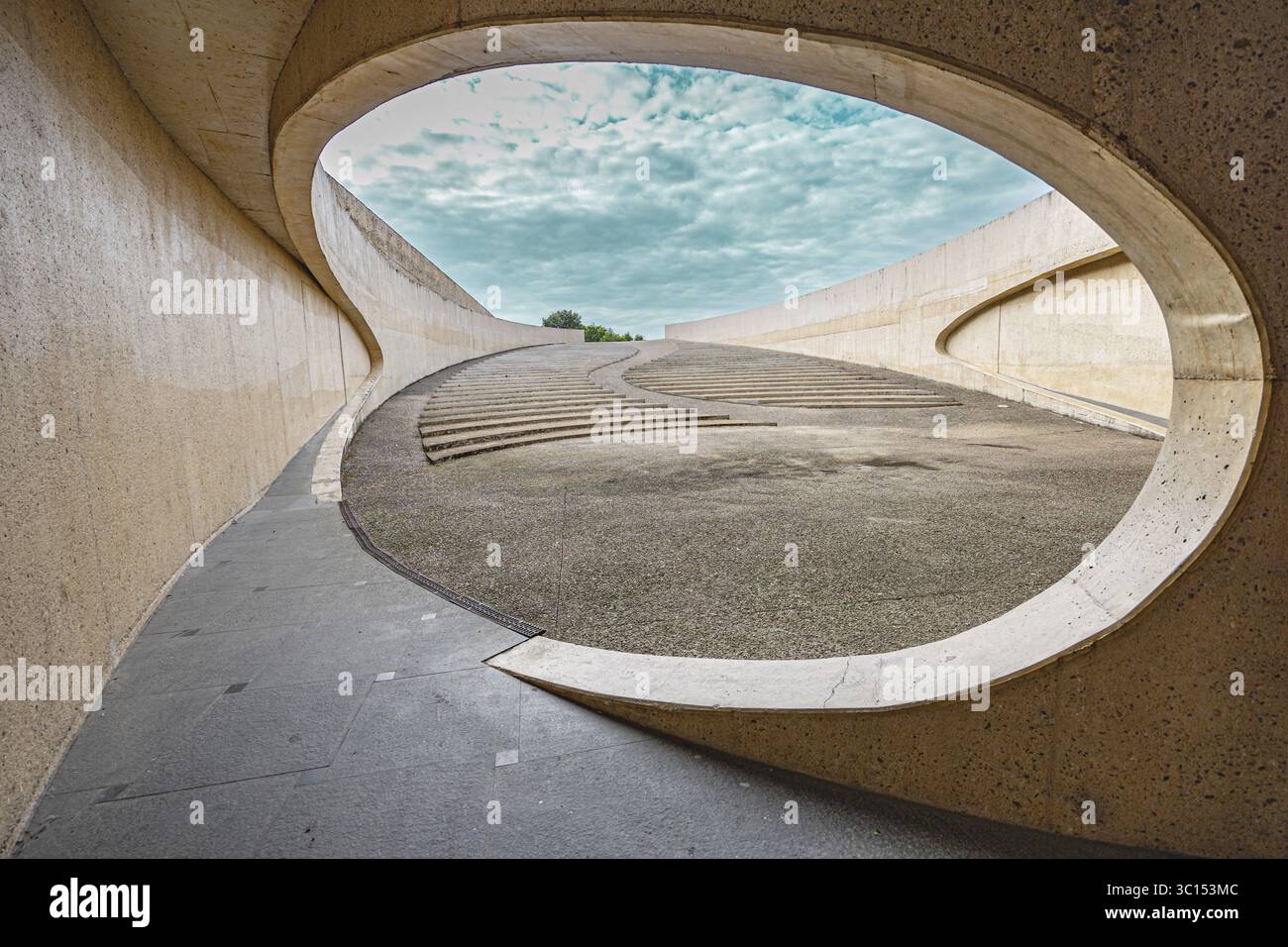 View through an oval architectural structure to an open-air ...