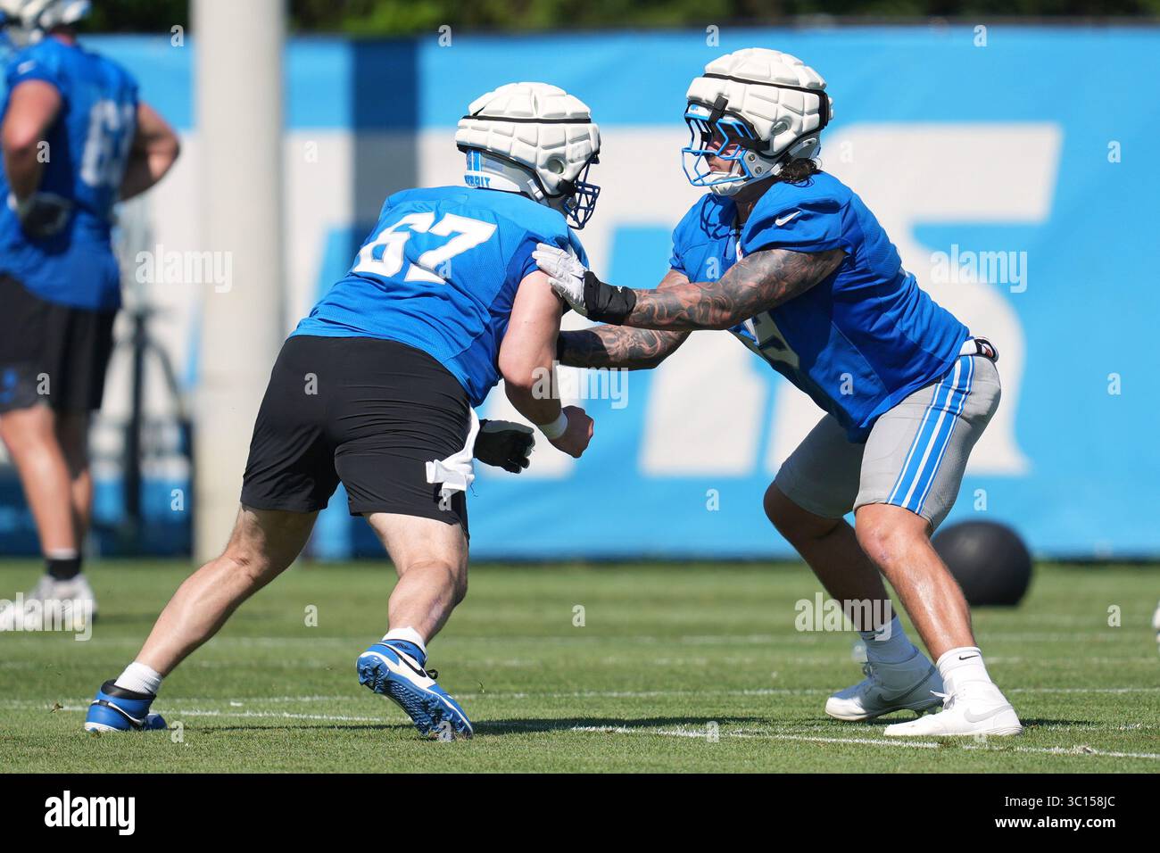 Detroit Lions offensive lineman Tate Ratledge, right, blocks Trystan ...