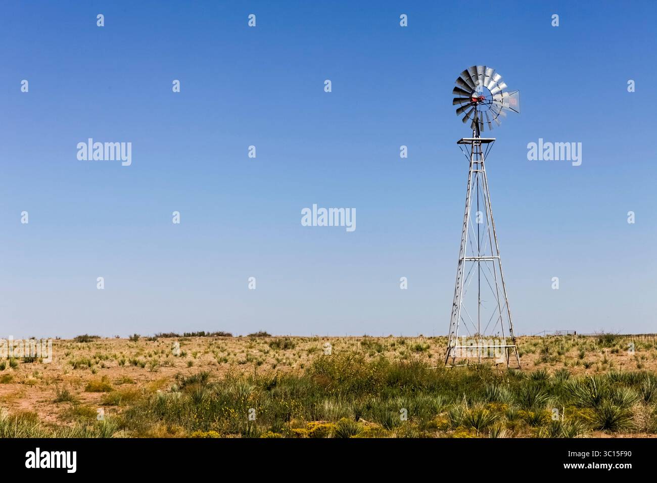Endee, New Mexico, USA. Route 66. Rustic old windmill blowing in the ...