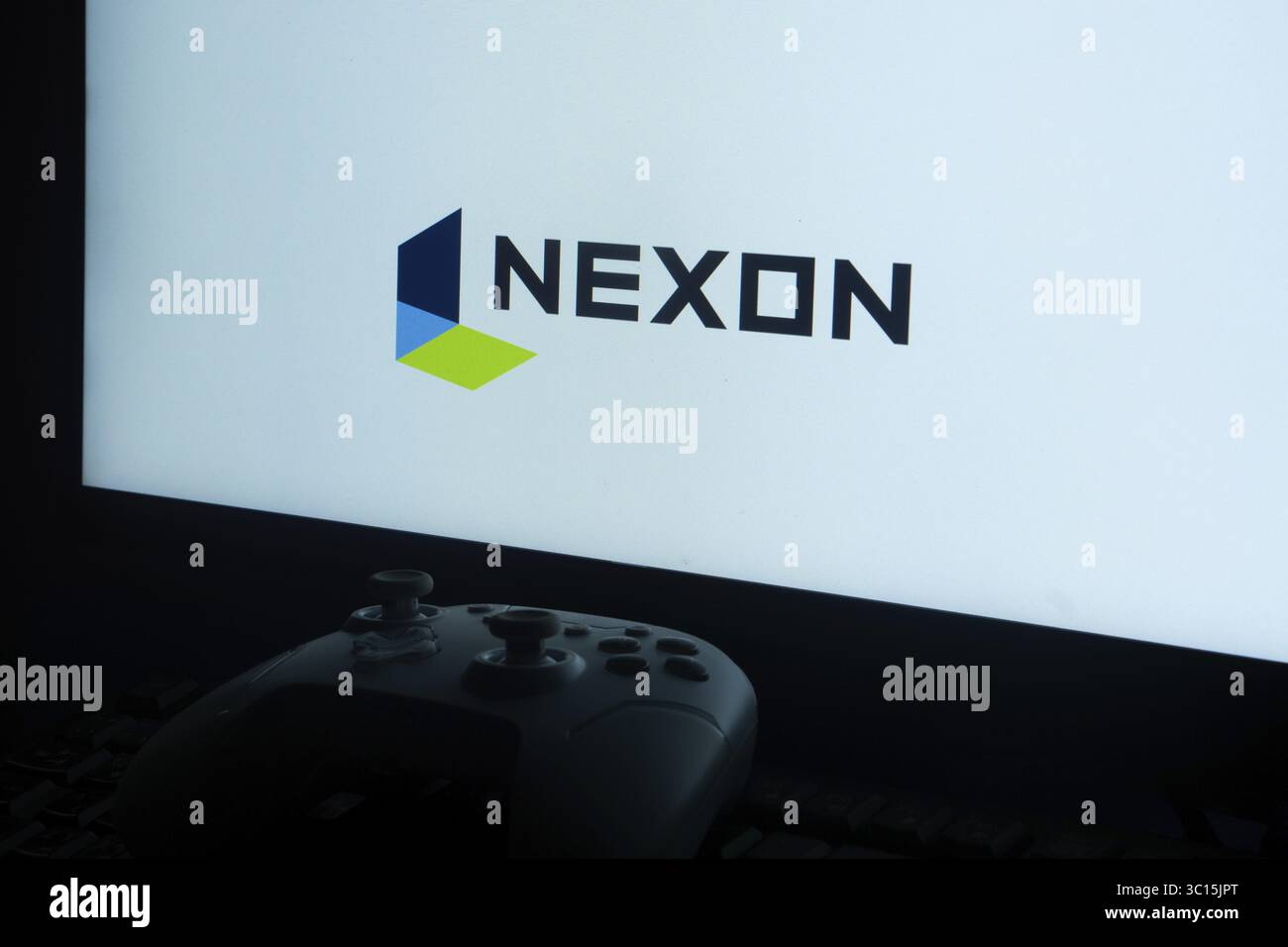 Gaming controller in front of a screen showing the Nexon logo Stock ...