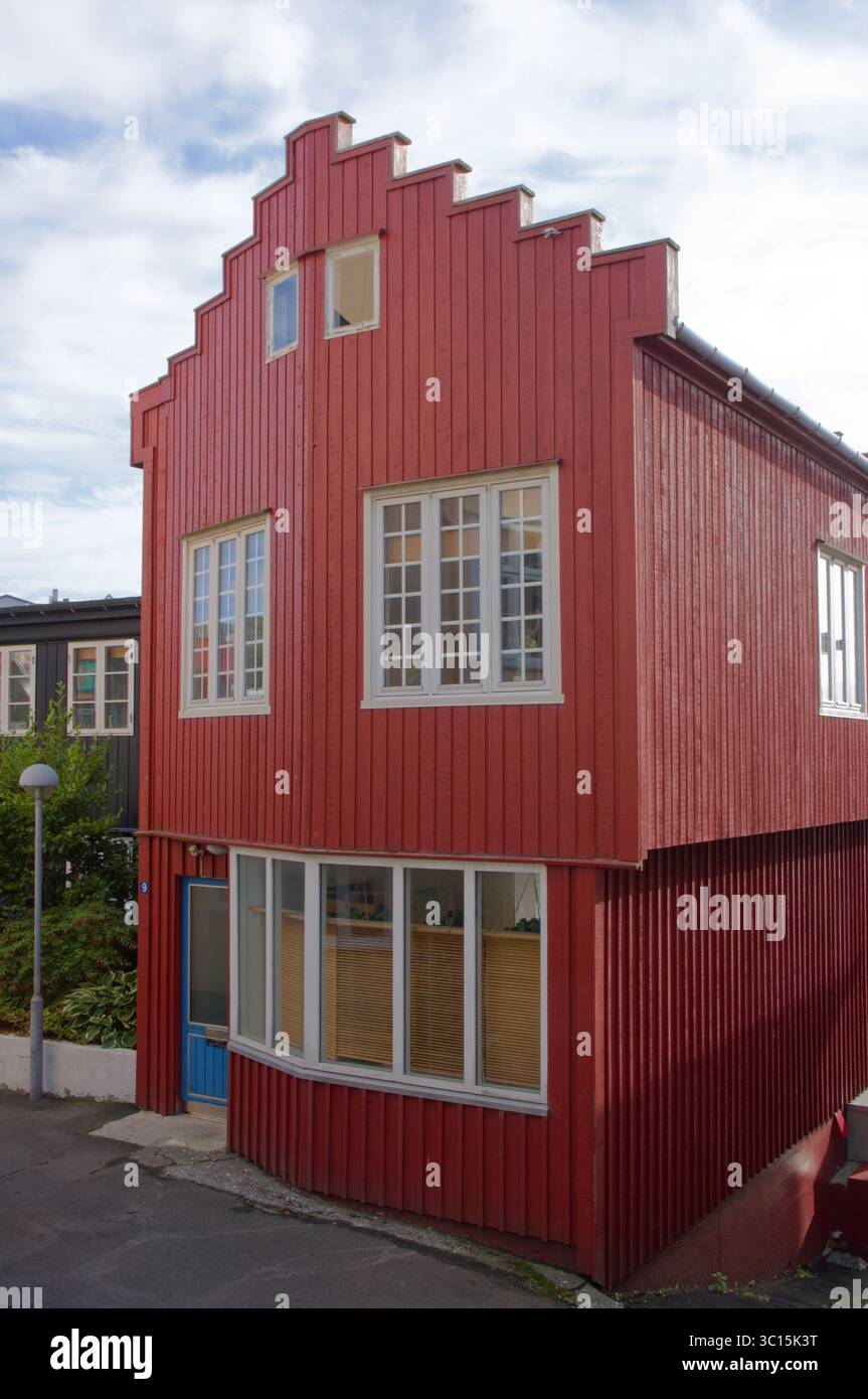 Traditional house with stepped gable roof and red-painted timber ...