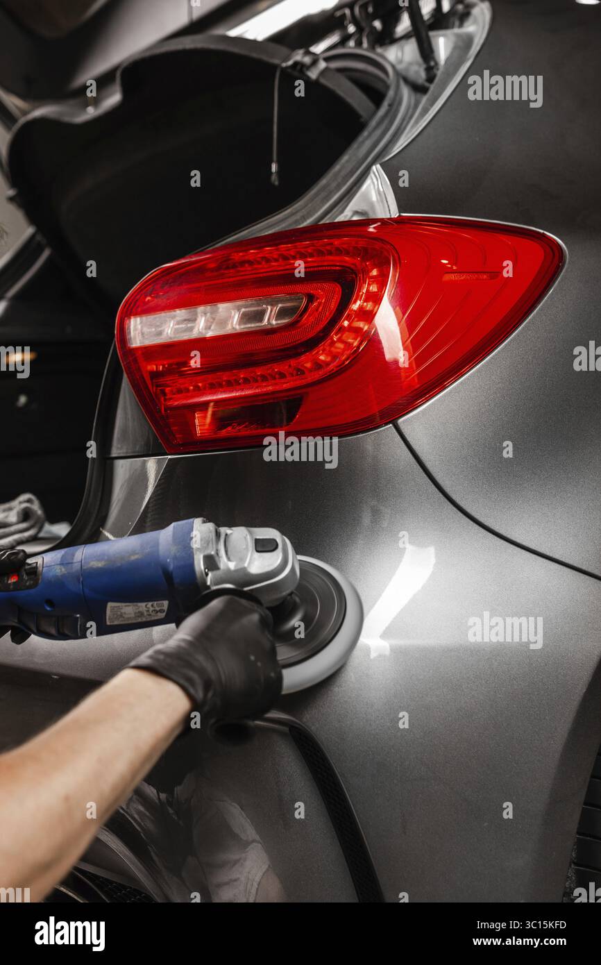 Car detailing and polishing concept with male worker. Polishing gray ...