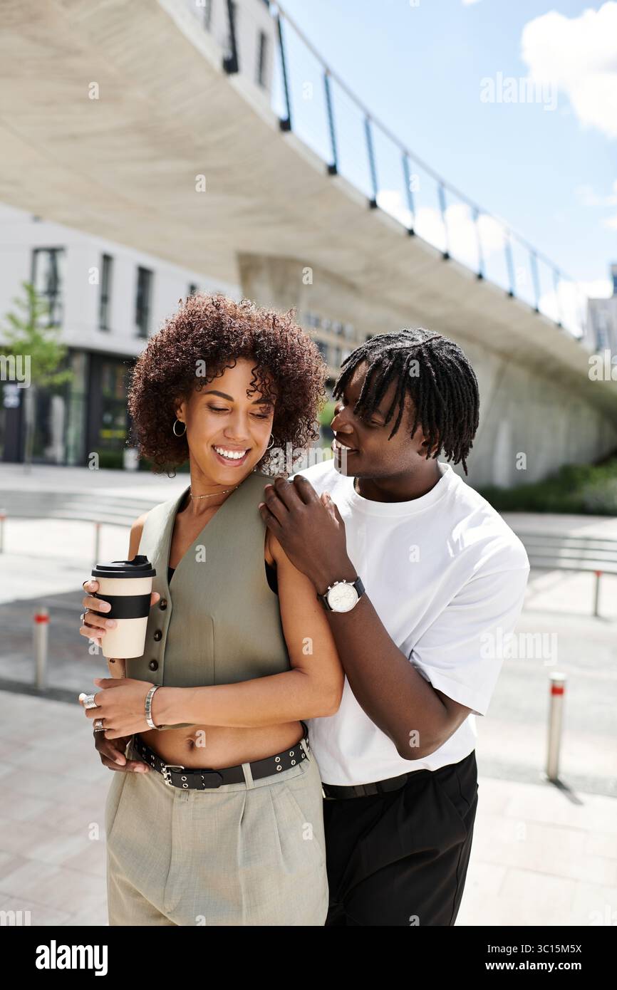 A young couple shares a joyful moment together in an urban setting ...