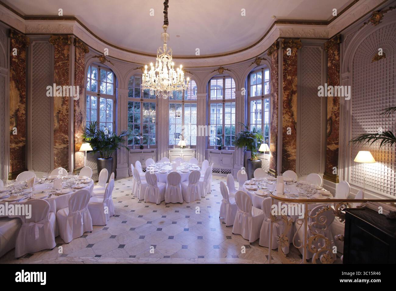 Elegant ballroom with chandelier and floor-to-ceiling windows, ready ...