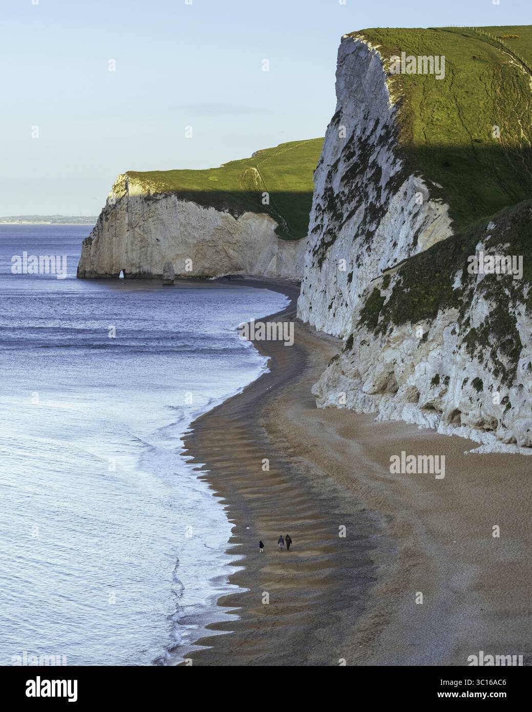 View of the rugged coastline where chalk cliffs meet the sandy shore ...