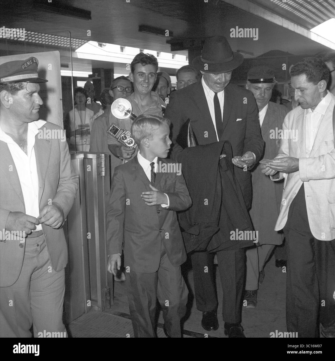 American actor Clark Gable with his stepson Adolph Spreckels surrounded ...