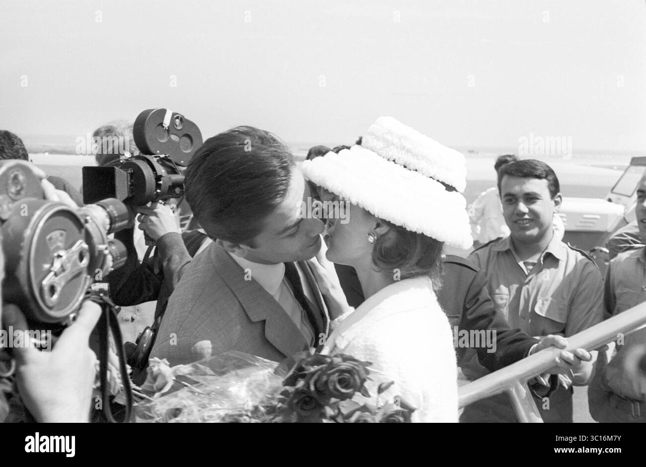 French actor, director and singer Alain Delon kissing his parter and ...