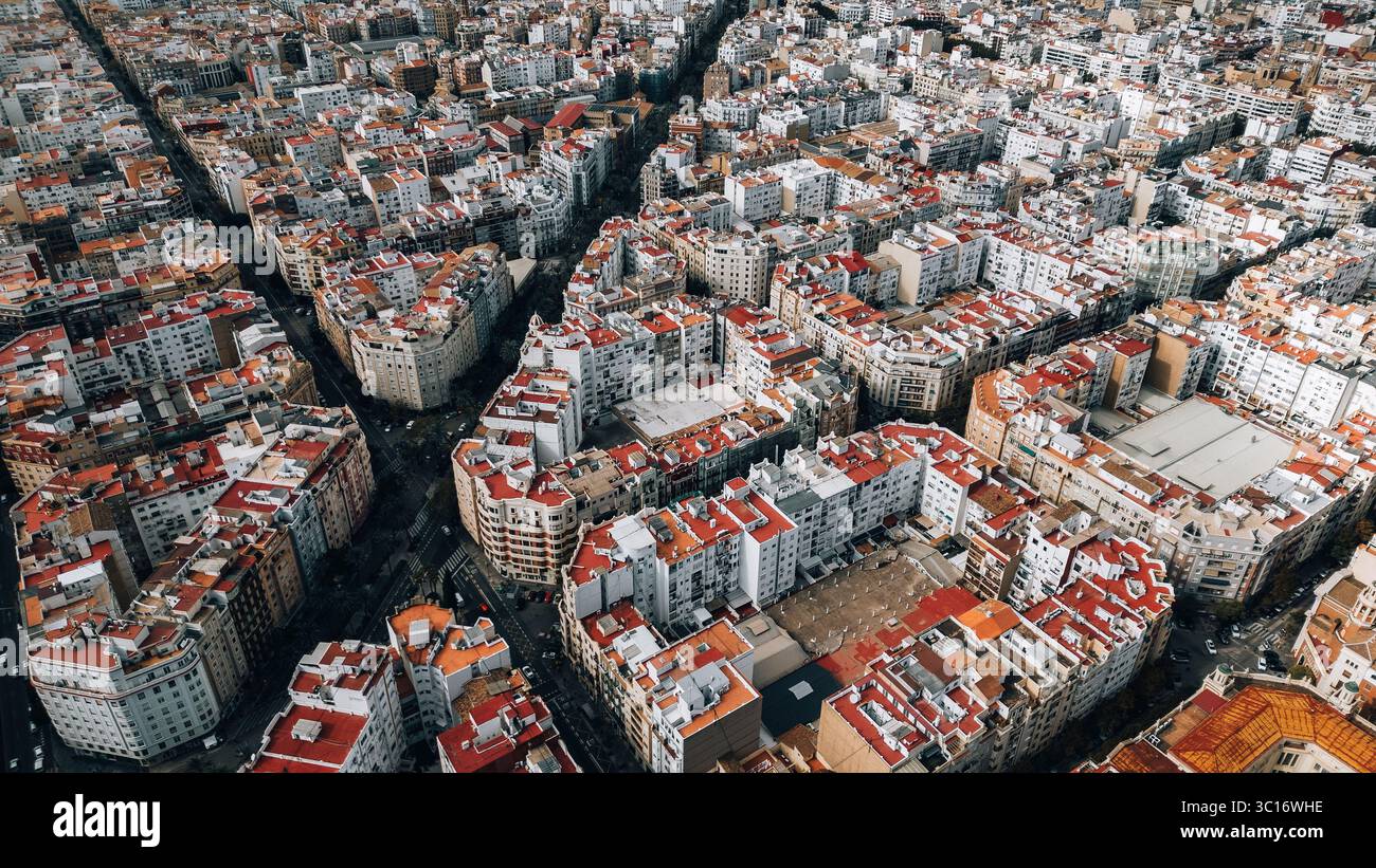Aerial view of a dense urban tapestry where buildings cluster together ...