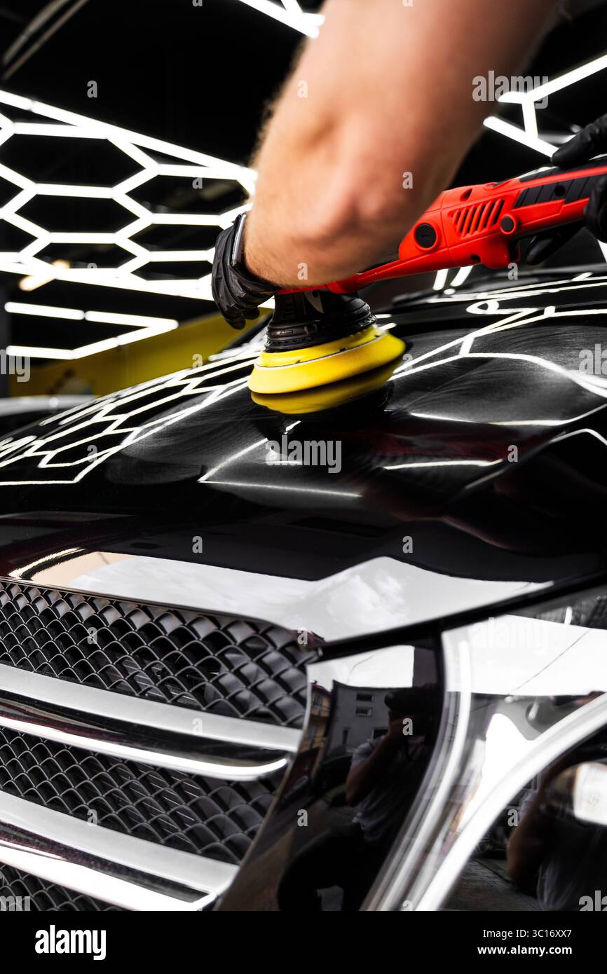 Car hood being polished with yellow pad. Paint polishing in active ...