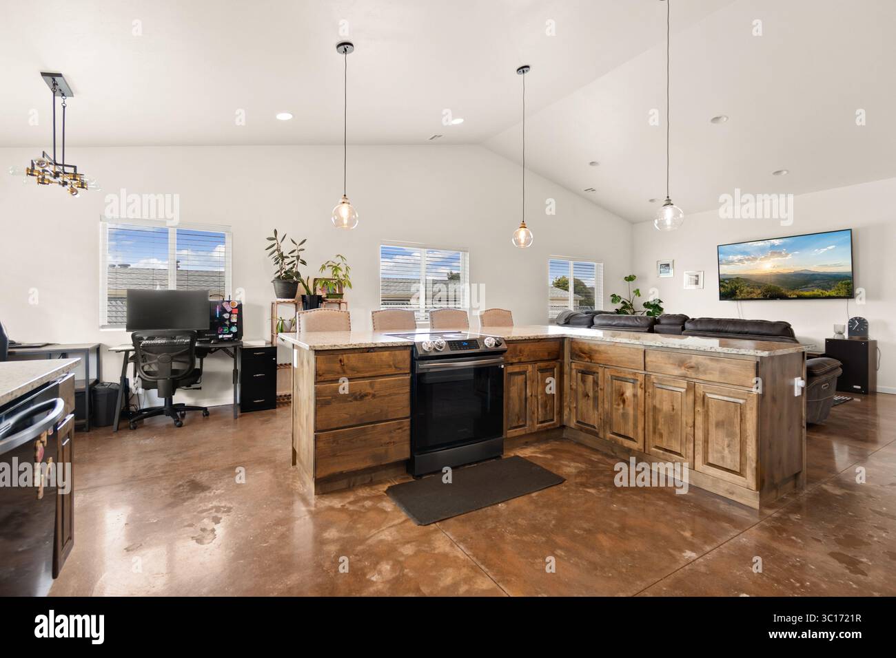 A beautifully designed kitchen featuring a spacious island situated ...