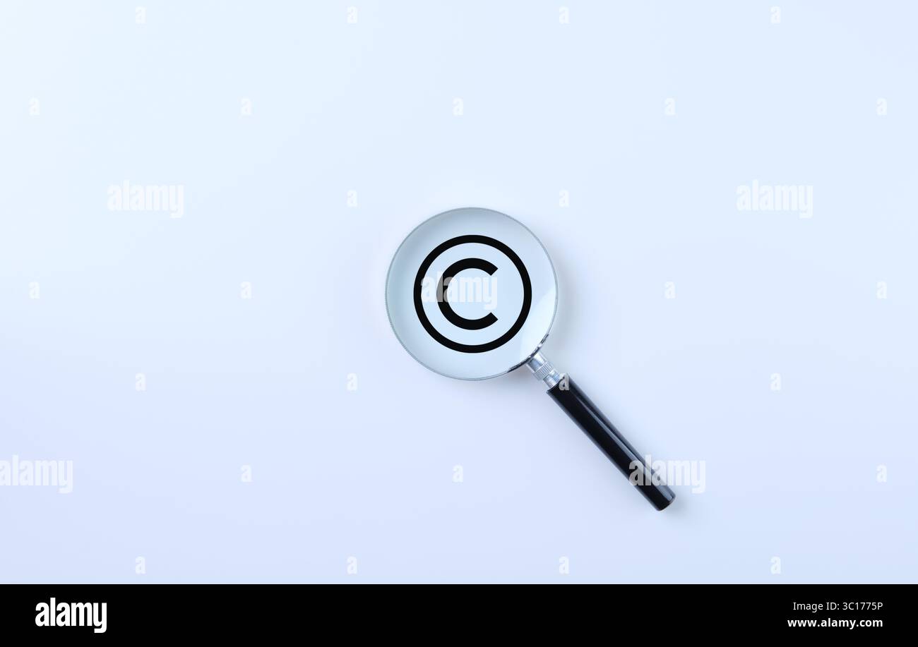 Copyright protection and patenting concept. Magnifying glass magnifies ...
