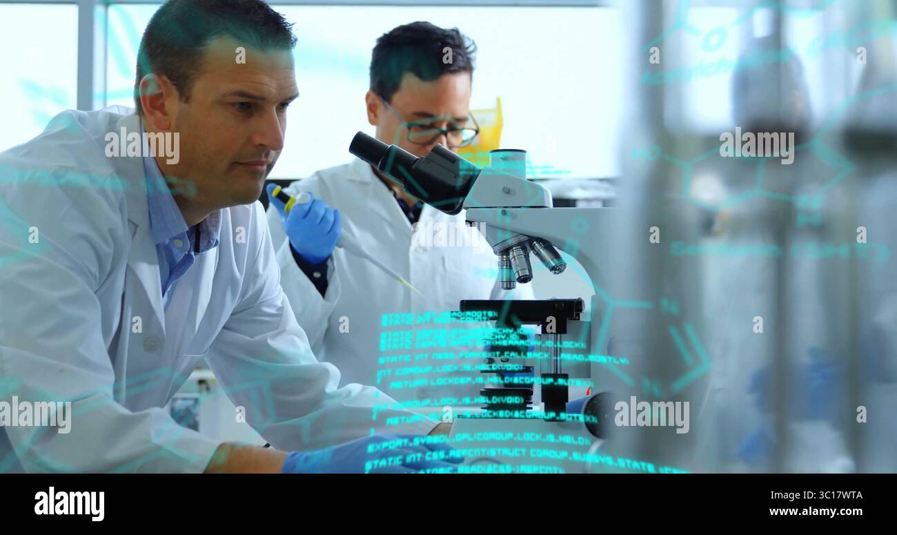White-coated scientists examining samples at lab bench, with microscope ...