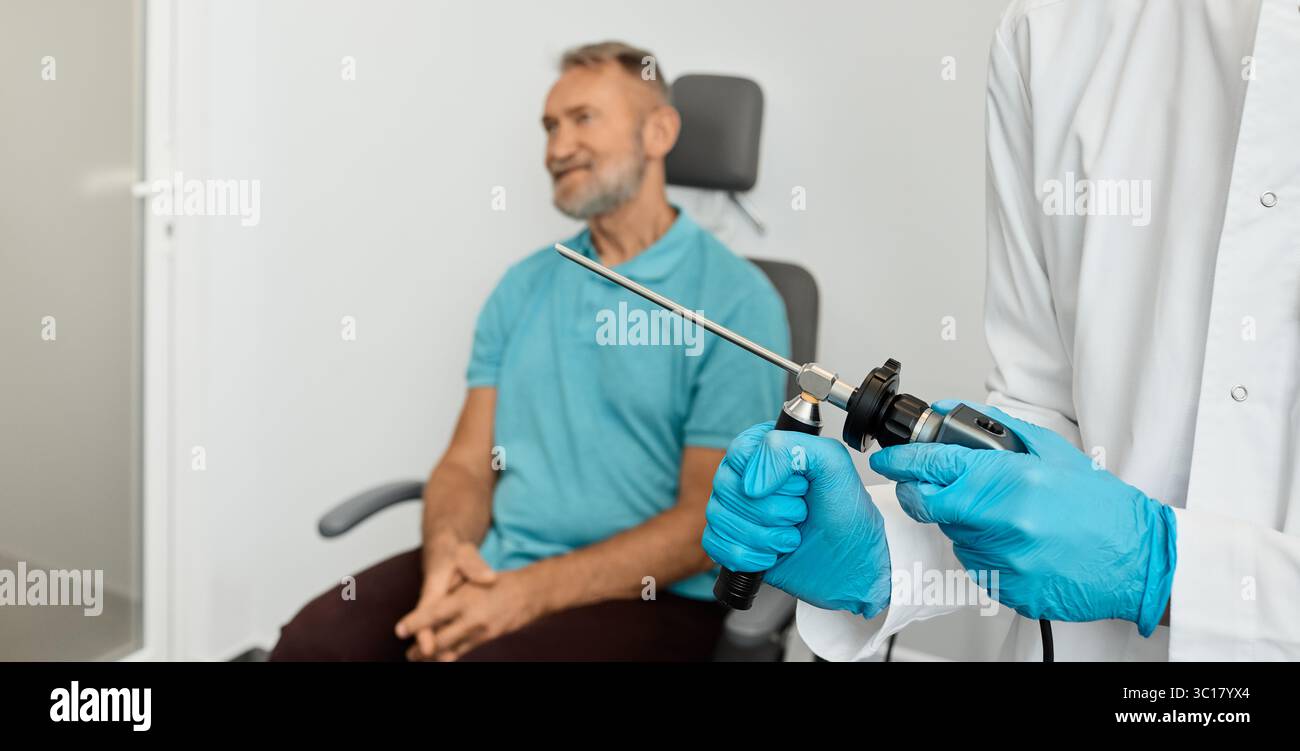 Doctor otolaryngologist holding video-endoscope for endoscopic check-up ...