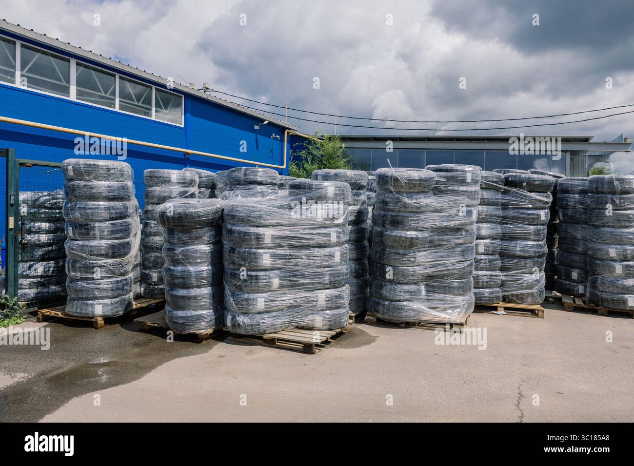Film packed stock of rolled polyethene pipes Stock Photo - Alamy