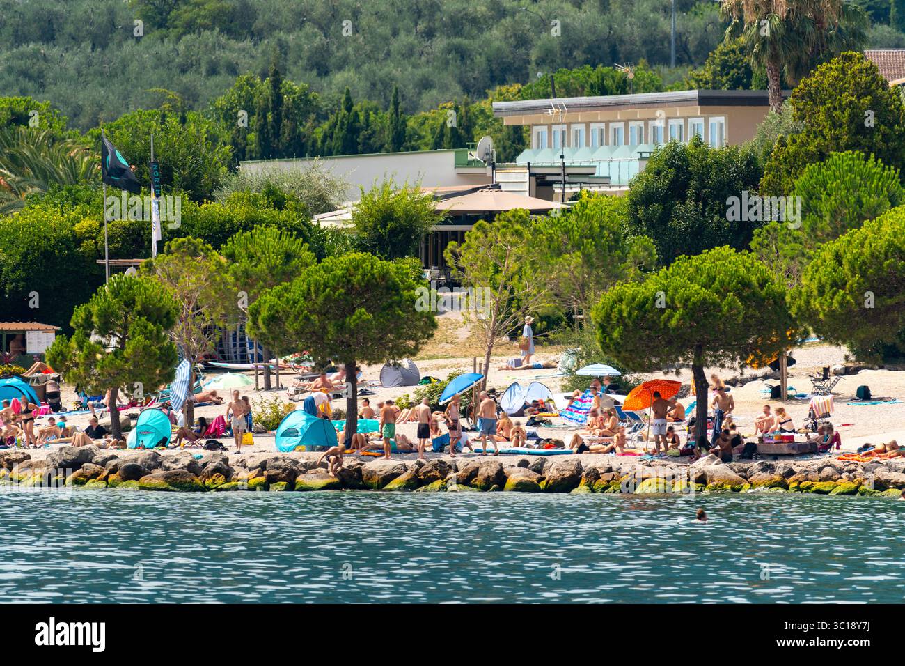 Limone, Lake Garda, Italy - July 20, 2025: The lively beach of Limone ...