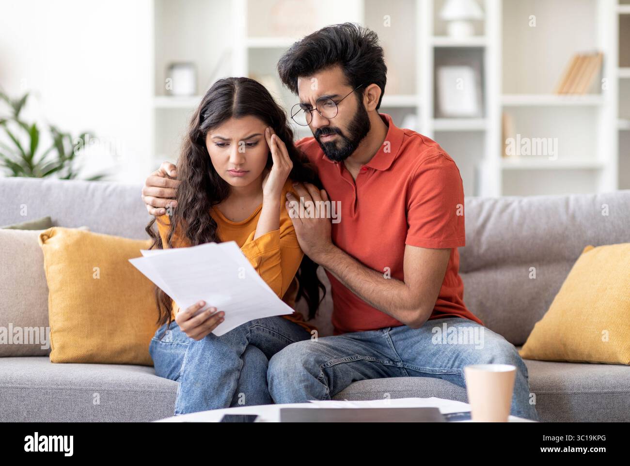Bad News. Upset Indian Couple Reading Letter From Bank At Home Stock ...