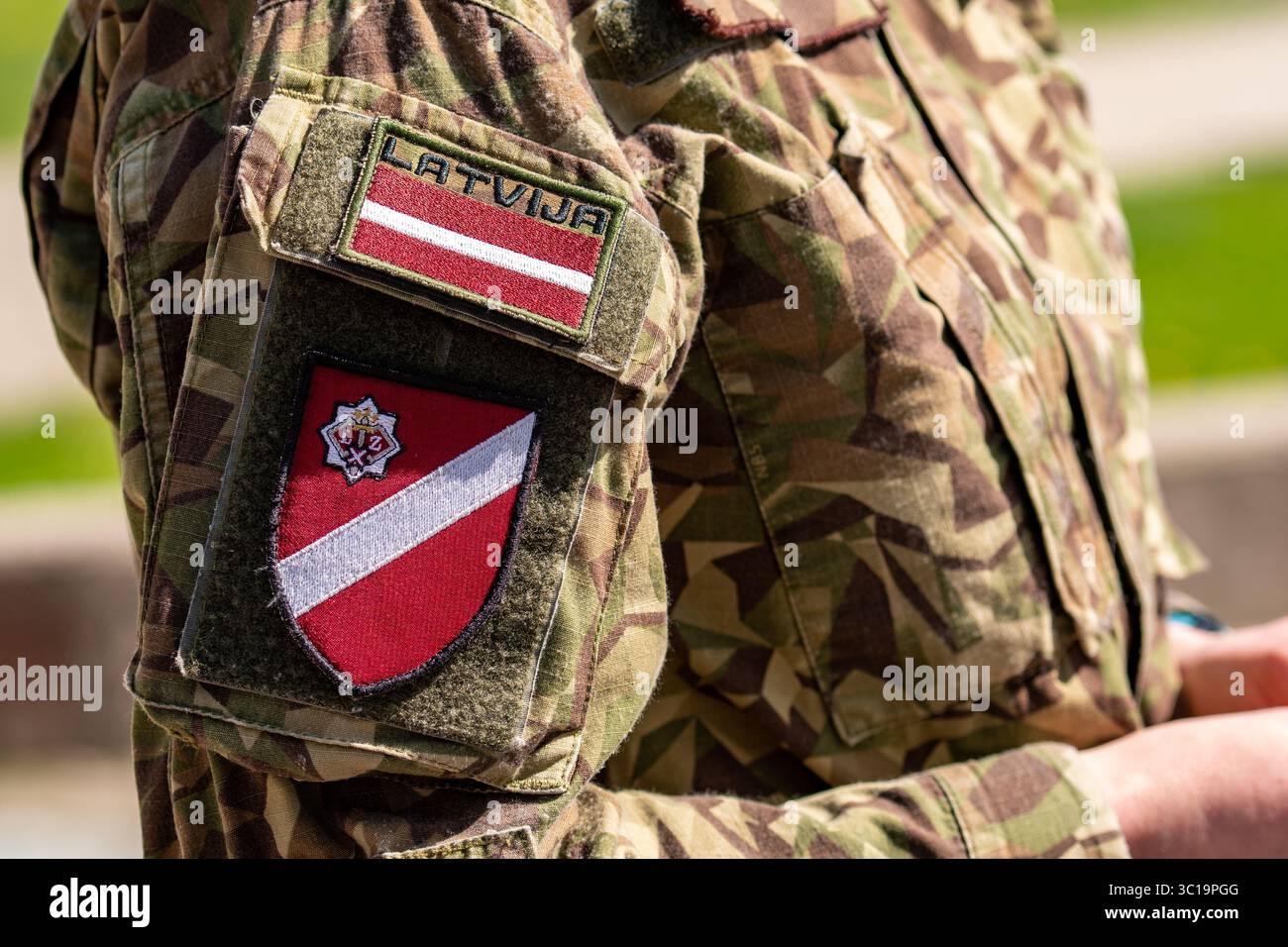 Latvian National Armed Forces with flag of Latvia on a soldier uniform, NATO force integration ...