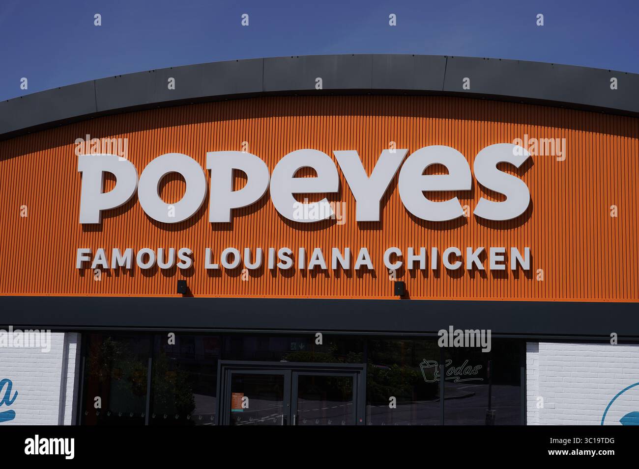 Popeyes fast-food chicken drive through from Louisiana. Corporate logo ...