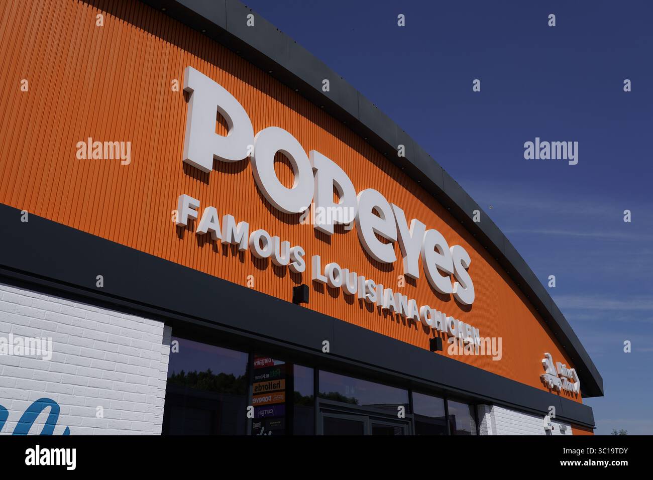 Popeyes fast-food chicken drive through from Louisiana. Corporate logo ...