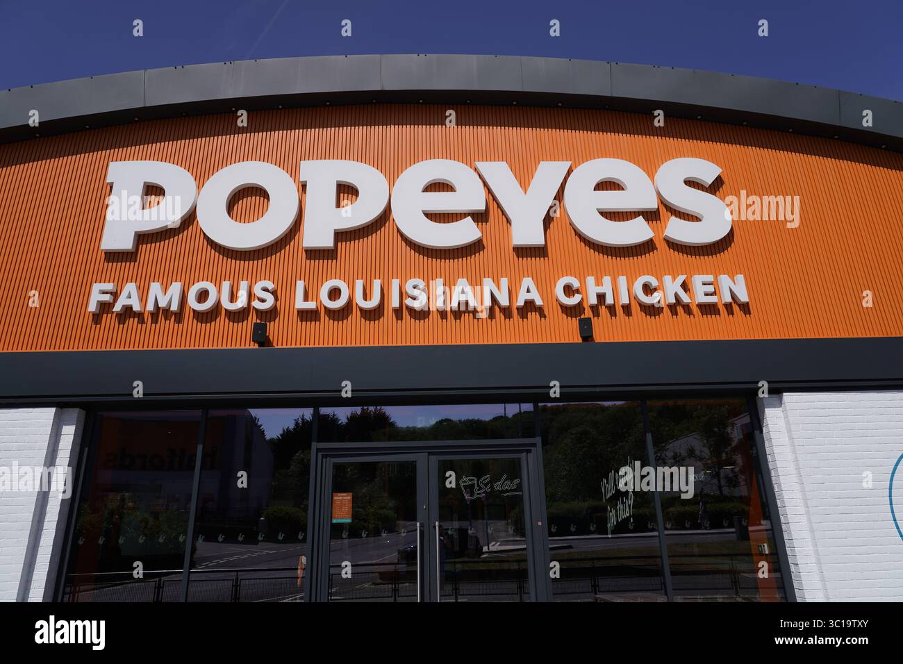 Popeyes fast-food chicken drive through from Louisiana. Corporate logo ...