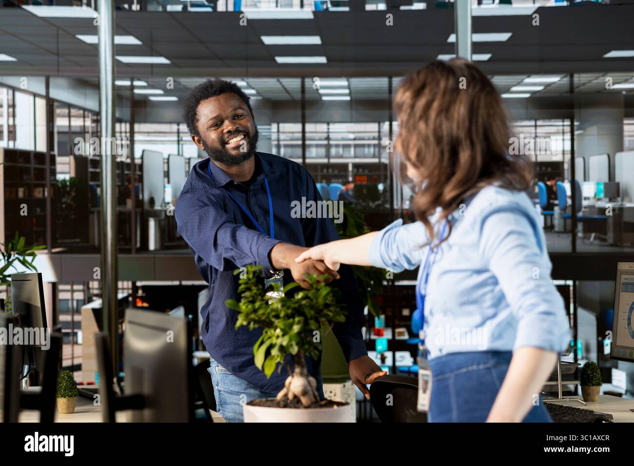 Multiethnic business workers greeting their new colleague at the office ...