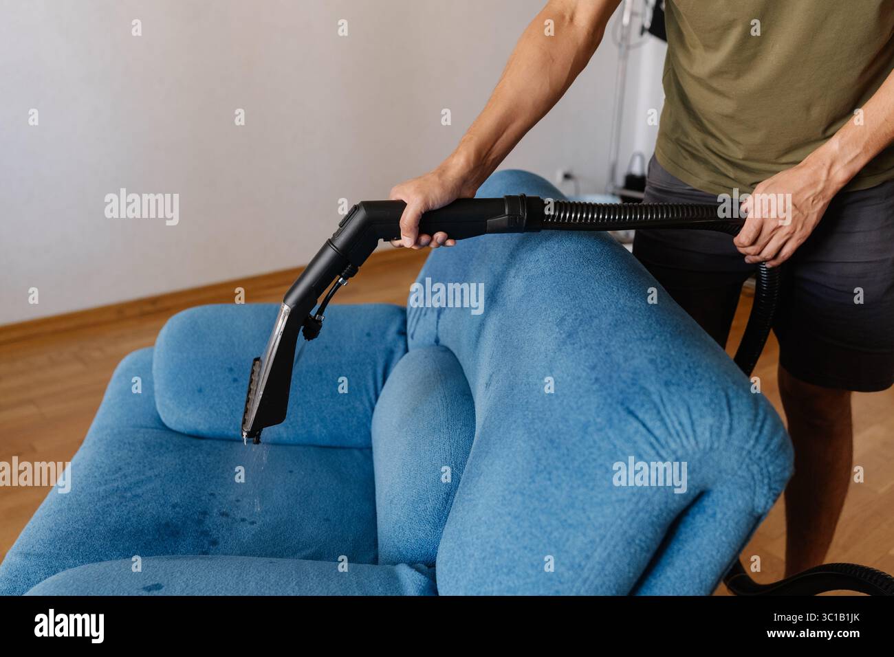 Cleaning service worker using a washing vacuum cleaner to remove dirt ...