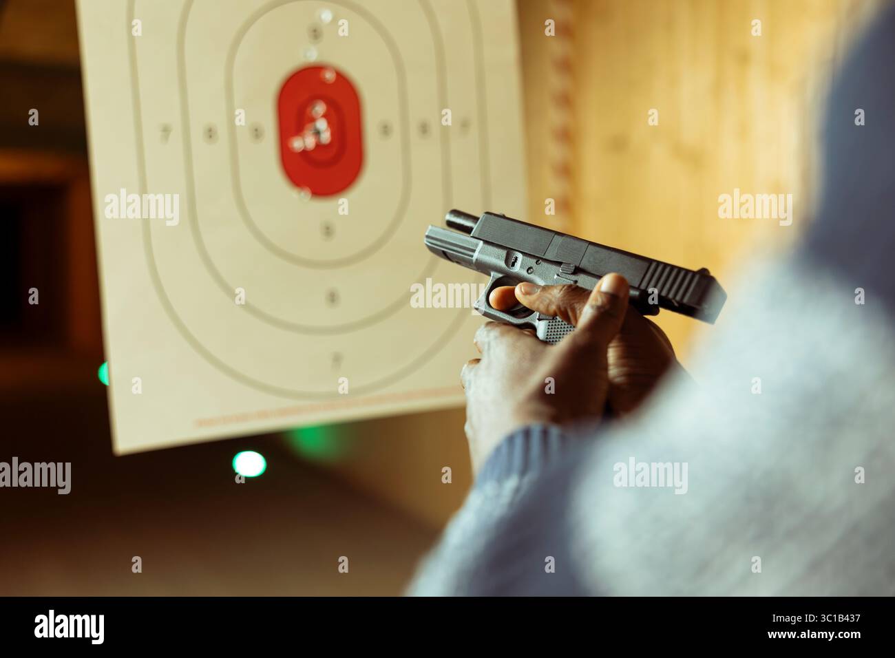 Man holding gun enjoying recreational indoor shooting experience in ...