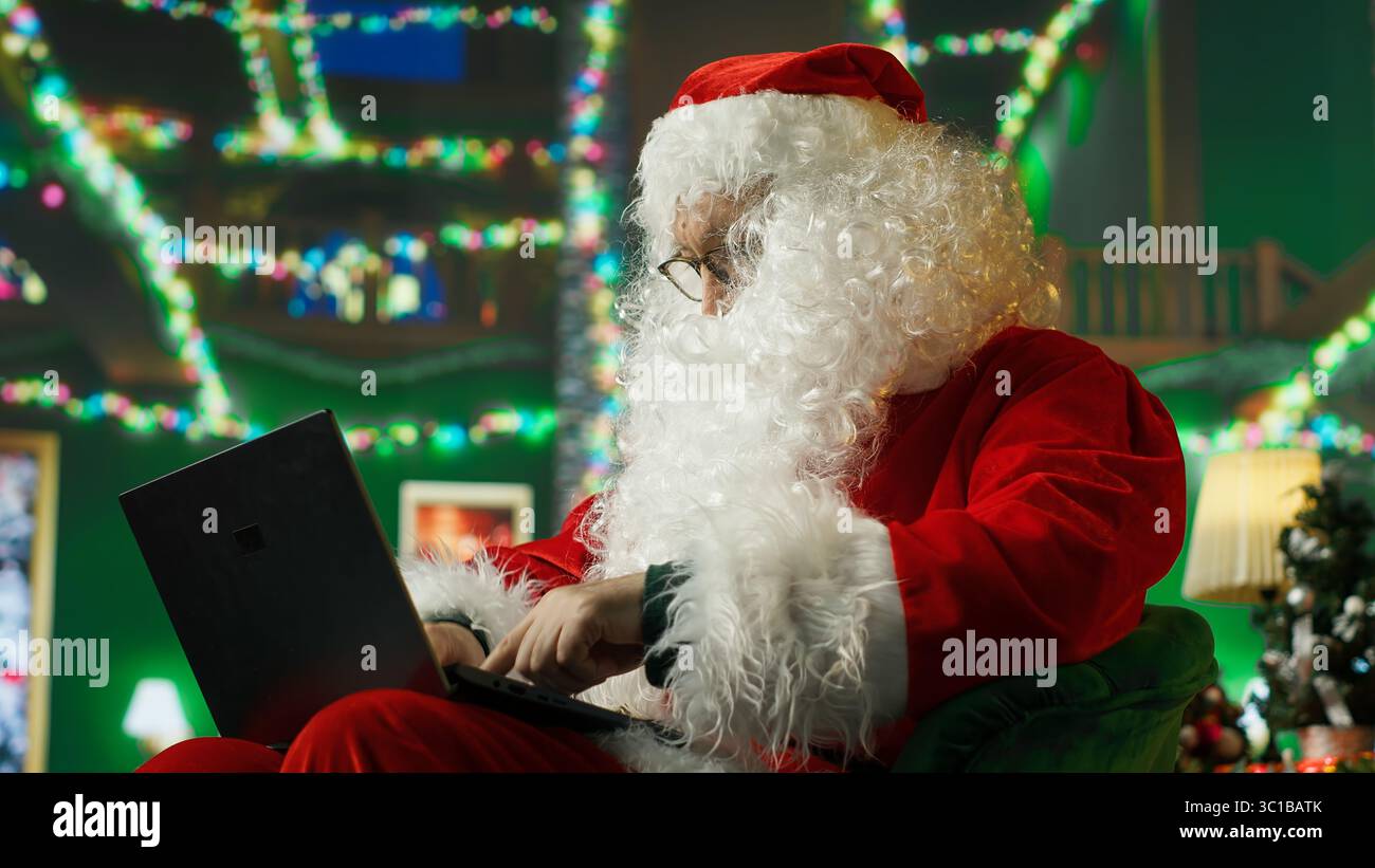 Man dressed as Santa Claus responding to kids requesting gifts, typing ...