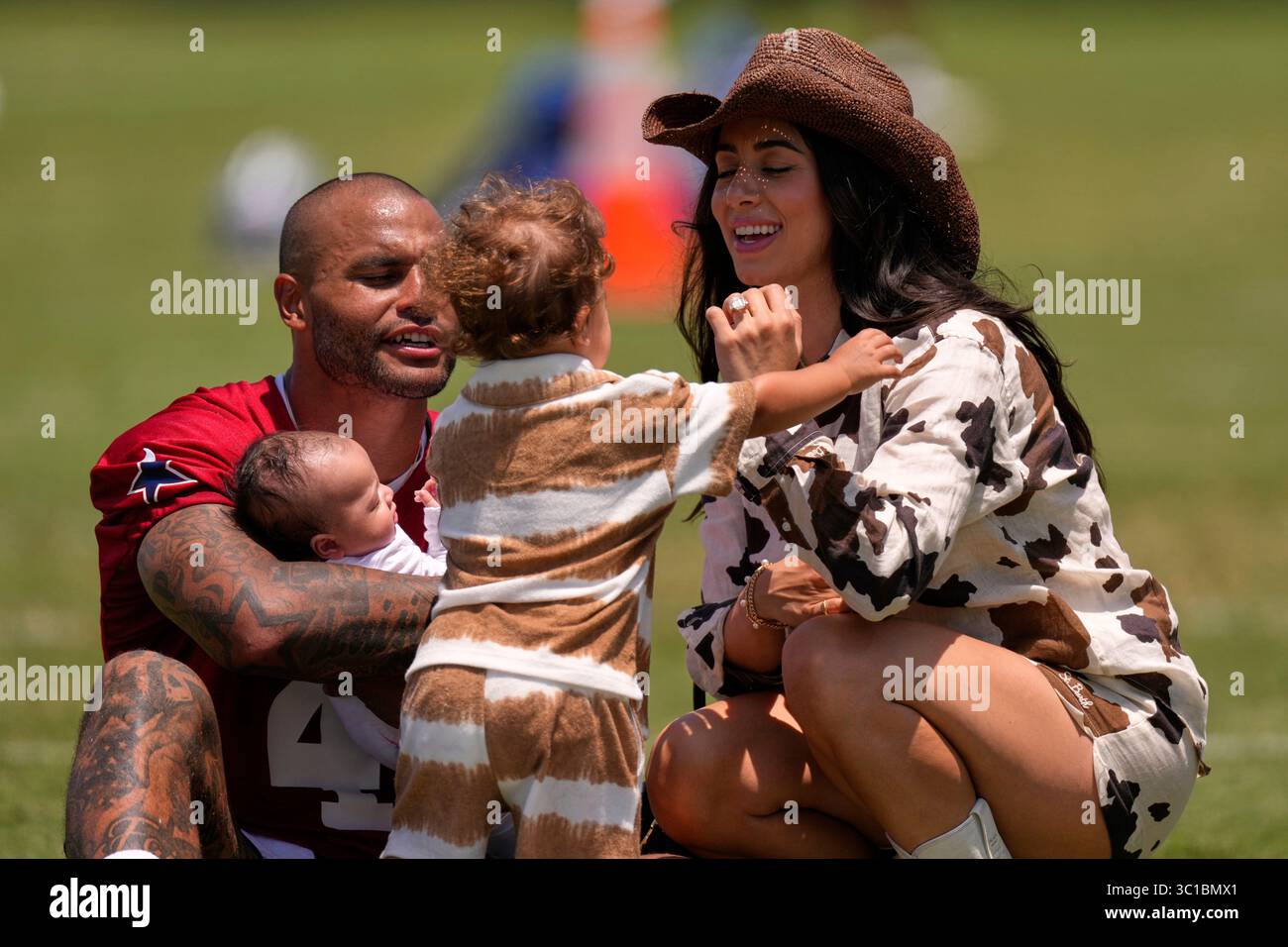 Dallas Cowboys quarterback Dak Prescott, left, holds his daughter ...