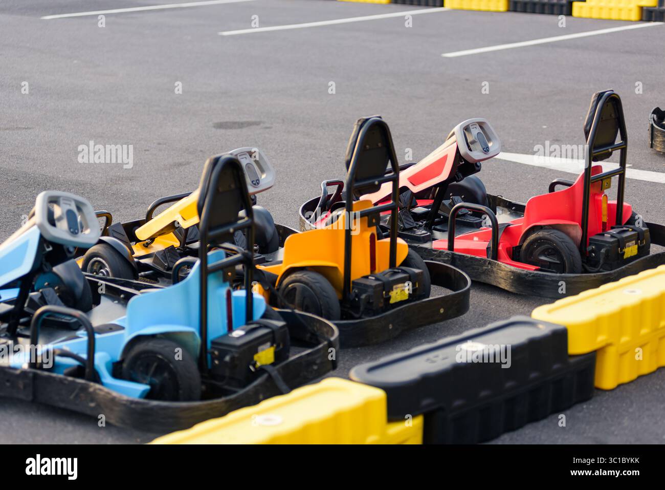 Go-kart race day. Drivers prepare as go kart machines are positioned ...