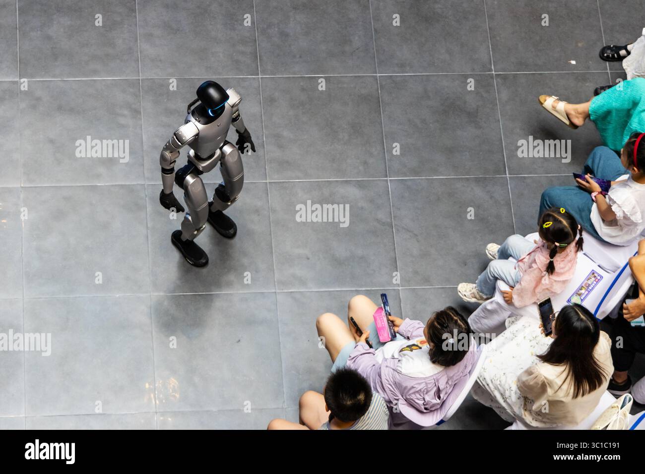 YANGZHOU, CHINA - JULY 22, 2025 - Citizens gathered around a Unitree humanoid robot in Yangzhou ...